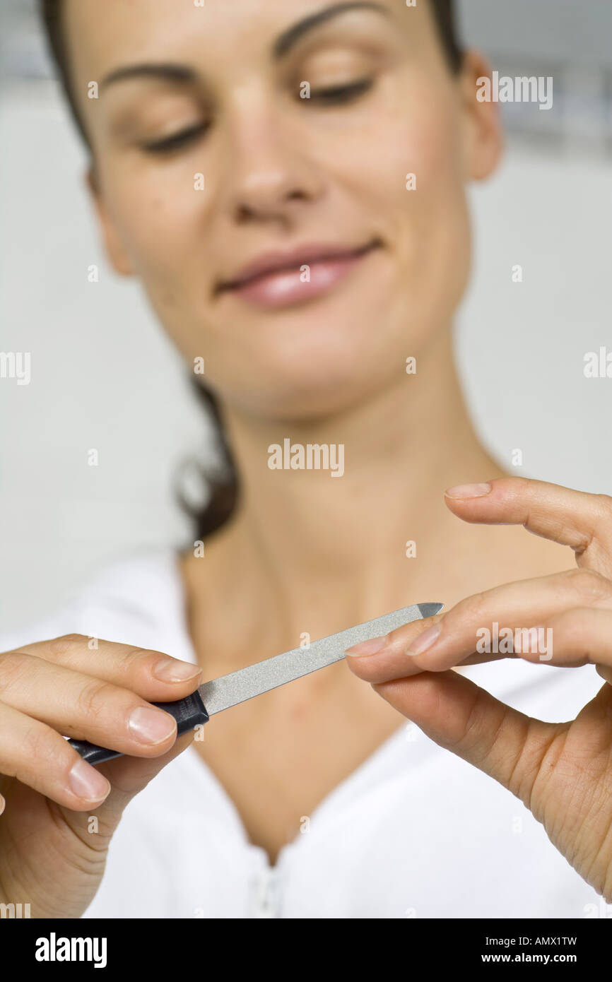 woman filing her nails Stock Photo - Alamy
