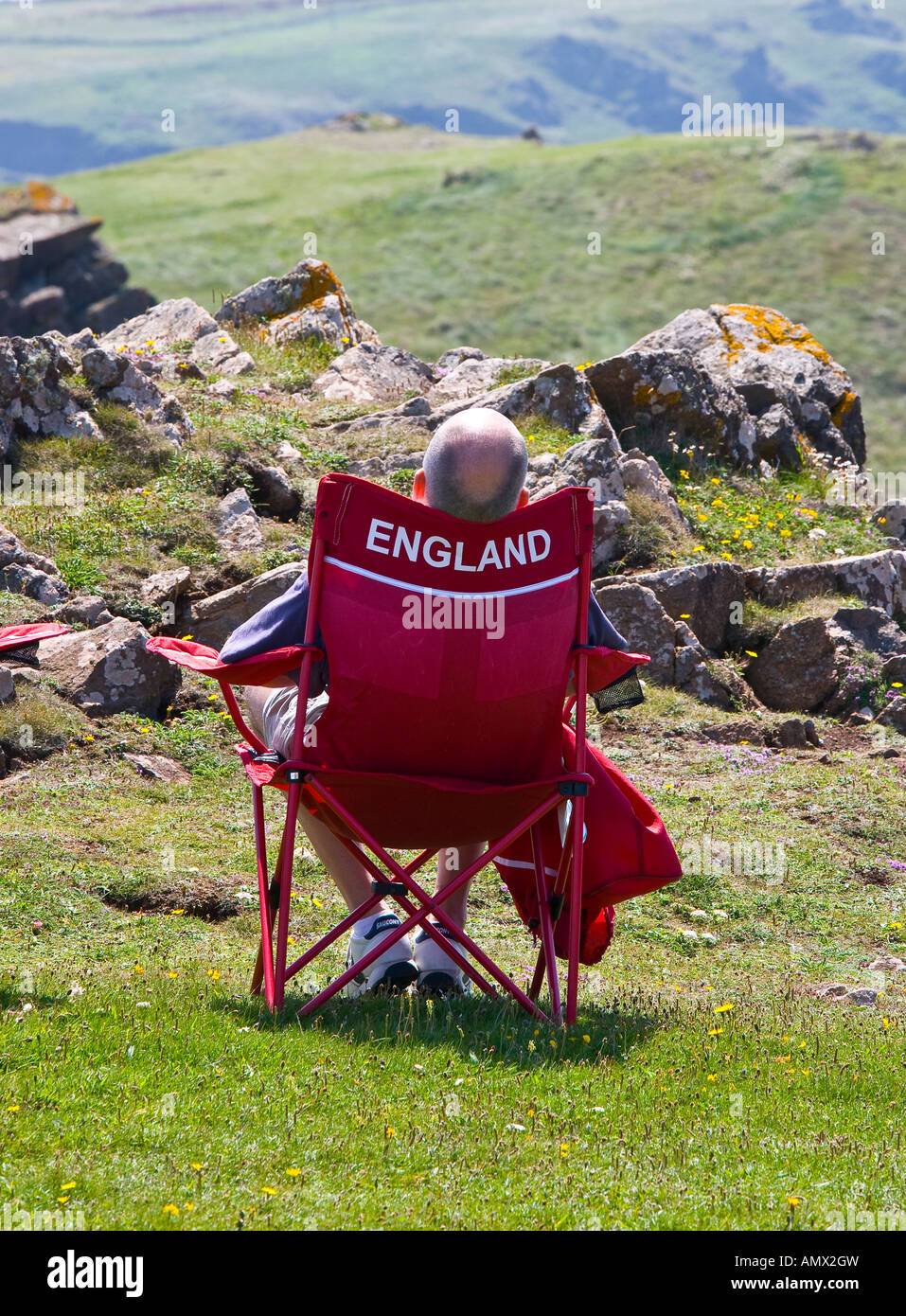 rear view of man reclining in england chair Stock Photo - Alamy