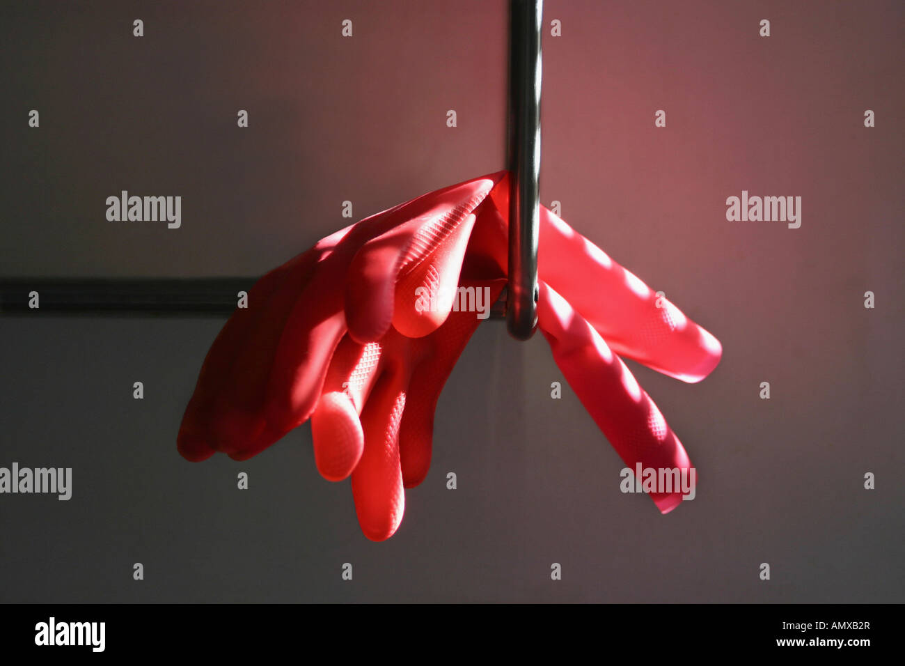 Red rubber washing up glove on drainer bathed in sunlight Stock Photo ...