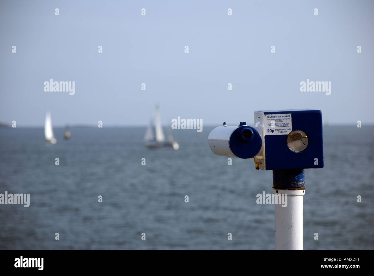 Telescope and view of sailing yachts Stock Photo - Alamy