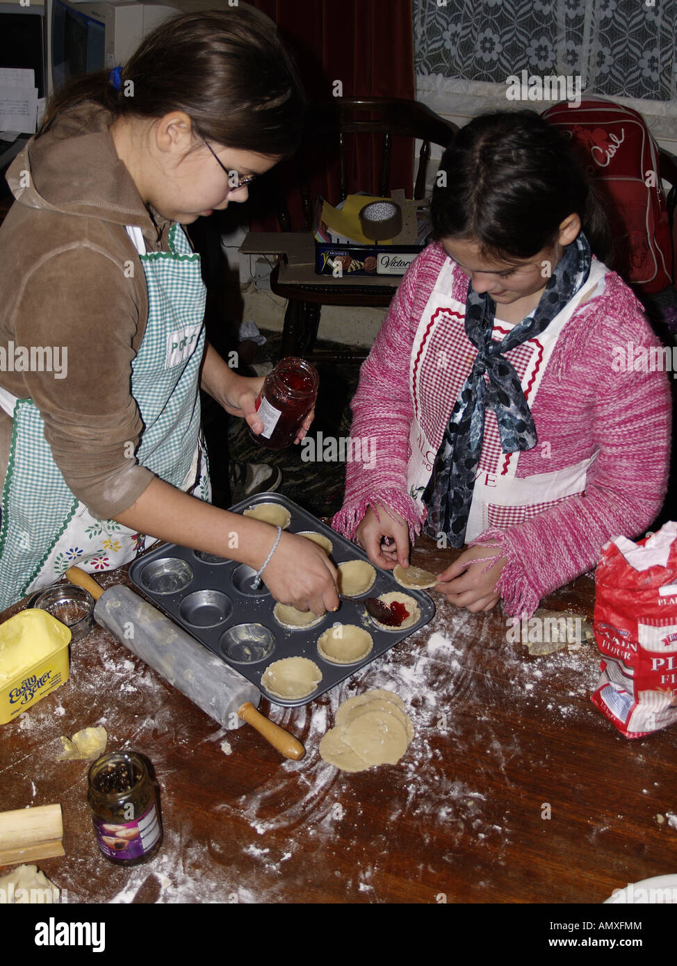 Two young girls making mince pies for Christmas Stock Photo - Alamy