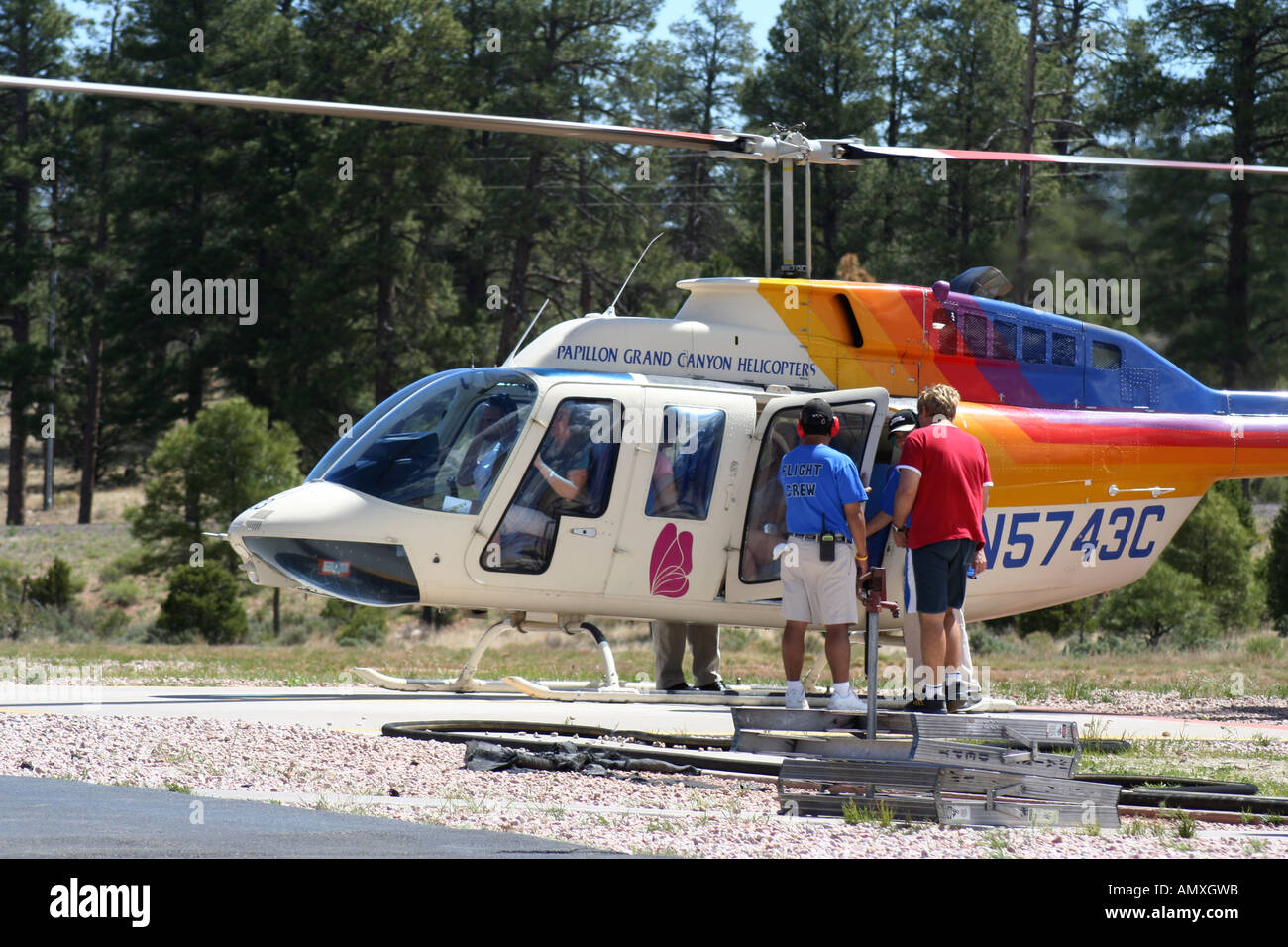 Tourists board a Papillon Grand Canyon Helicopter for an aerial tour of ...