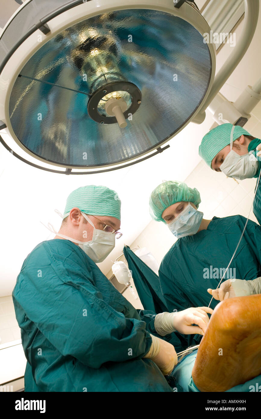Three surgeons operating patients in operation theatre Stock Photo - Alamy