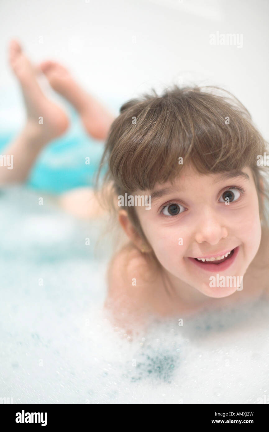Portrait of girl smiling in bathtub Stock Photo - Alamy