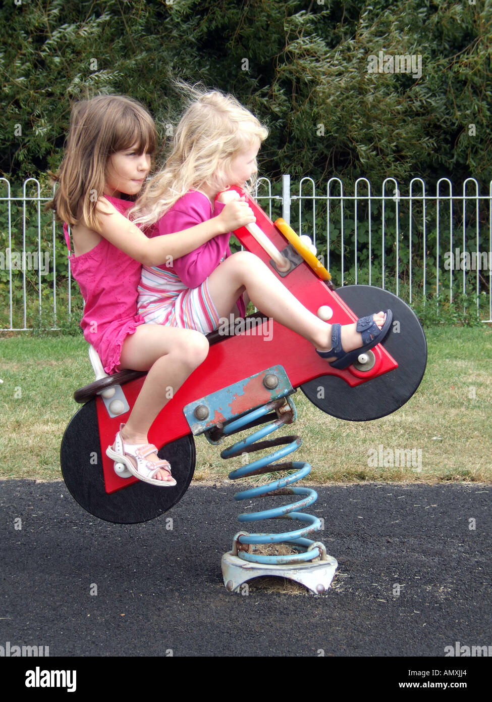 Two girls play in a park, Britain UK Stock Photo - Alamy