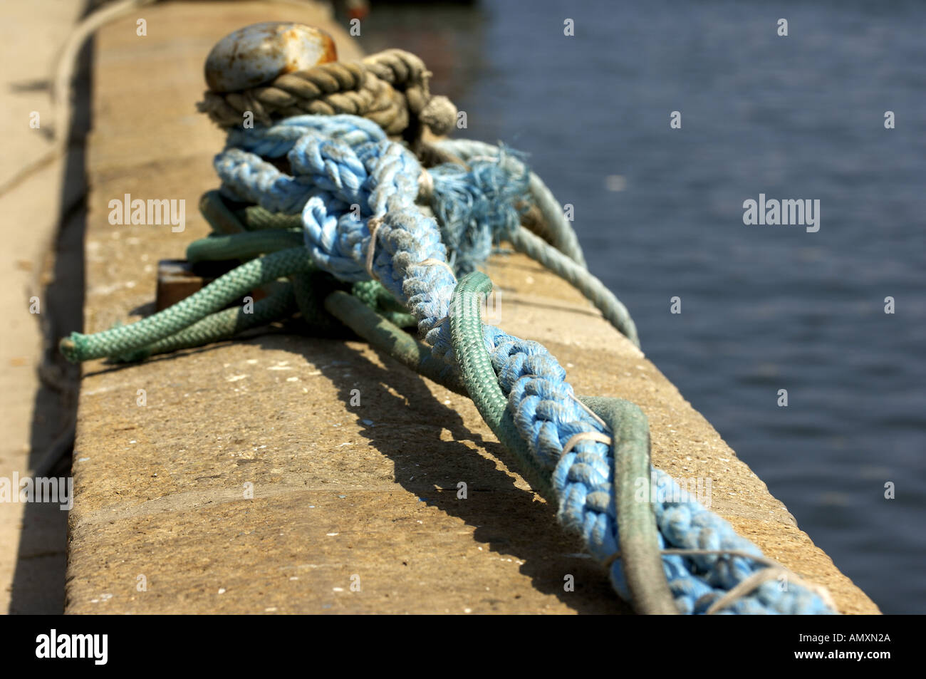 coloured ship rops lying on top of a quai wall Stock Photo - Alamy