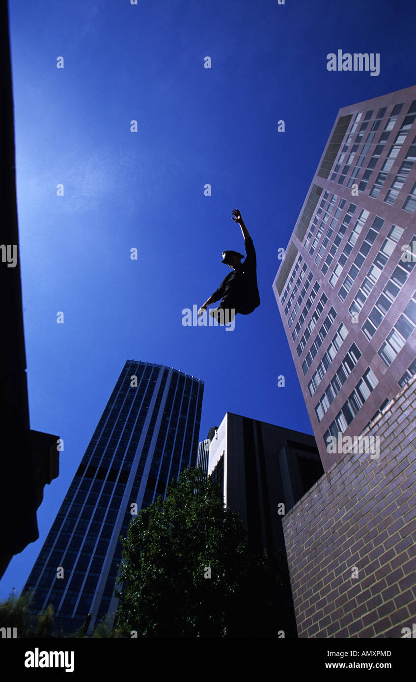 A Le Parkour of Free Runner leaps between buildings in the City of ...