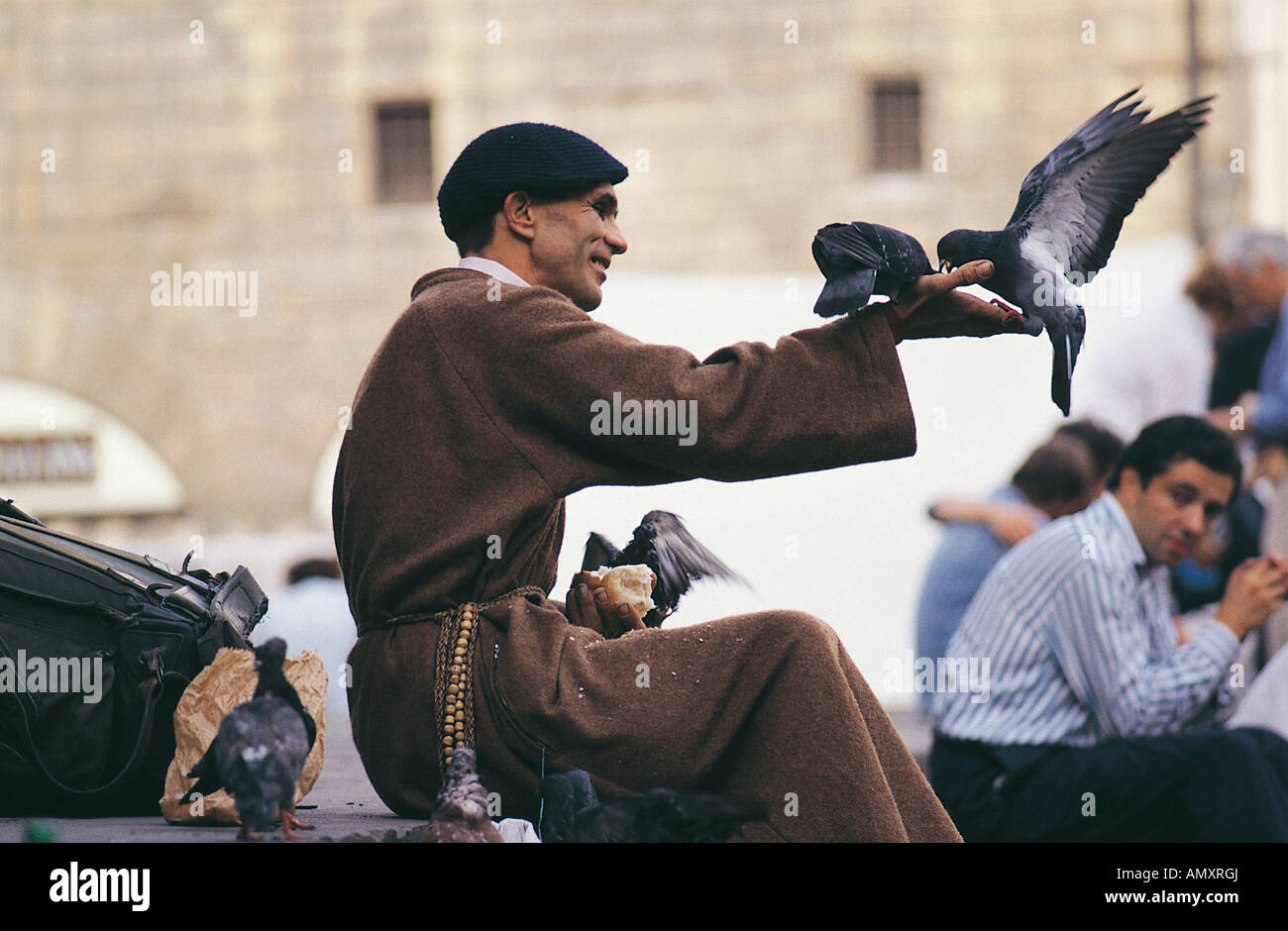 Monk feeding pigeons in front of church, Basilica Of Santa Croce ...