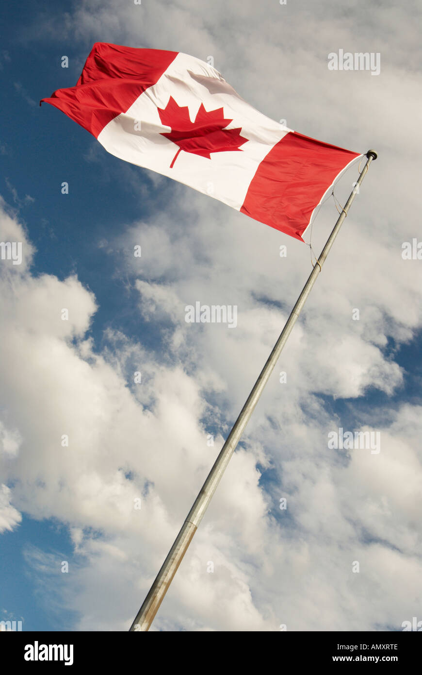 Canadian Flag with a dramatic, cloudy blue sky Stock Photo - Alamy