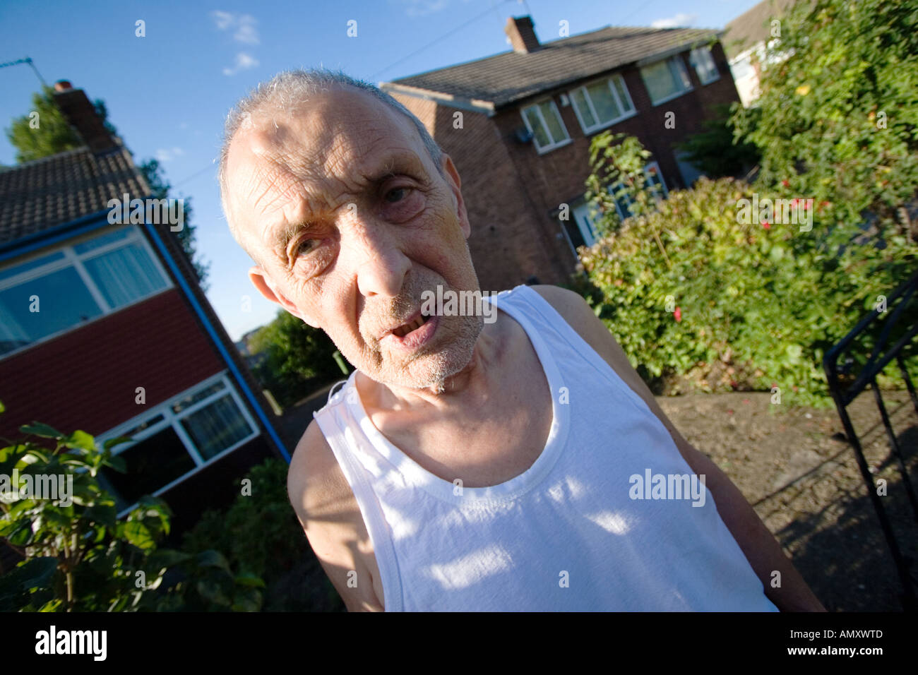 Photo of old man who is a homeowner outside property Stock Photo - Alamy