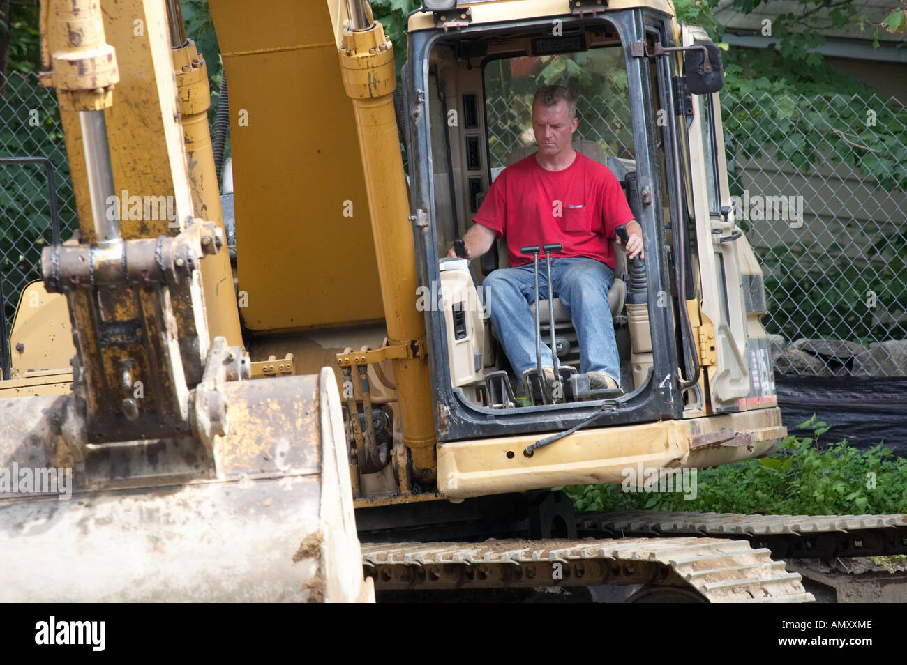 construction worker operating a backhoe Stock Photo - Alamy