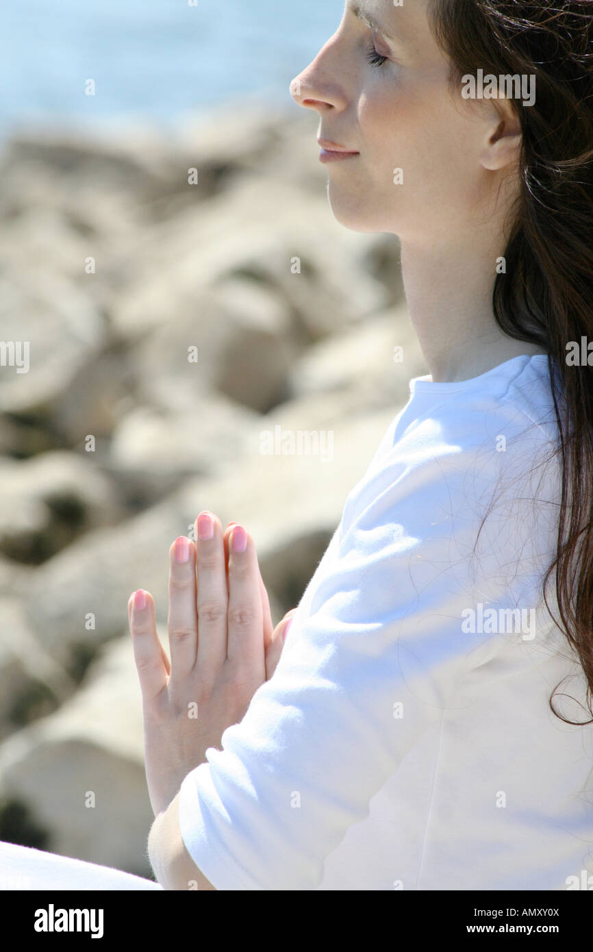 Side profile of woman meditating Stock Photo - Alamy