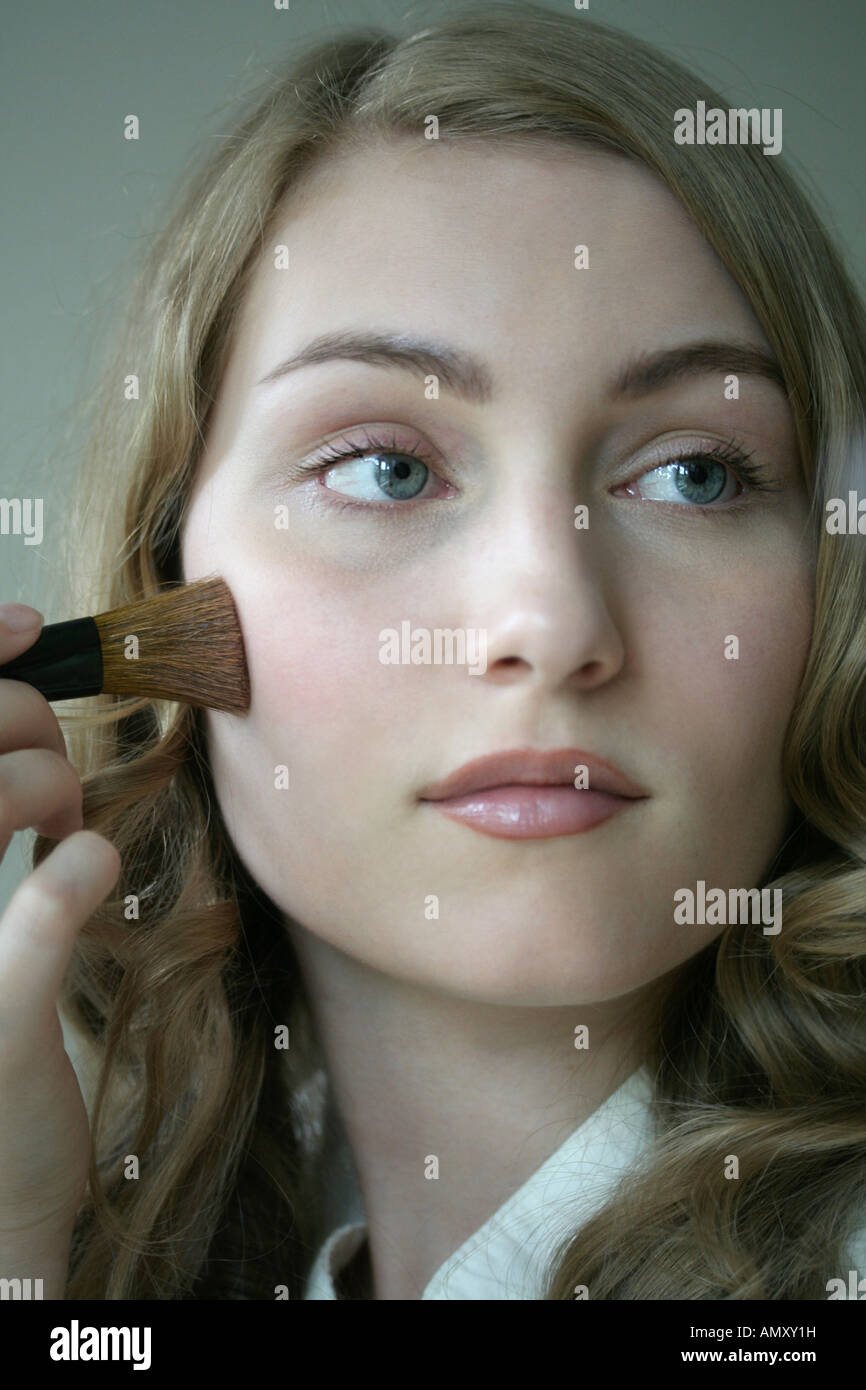 Young woman powdering face Stock Photo - Alamy
