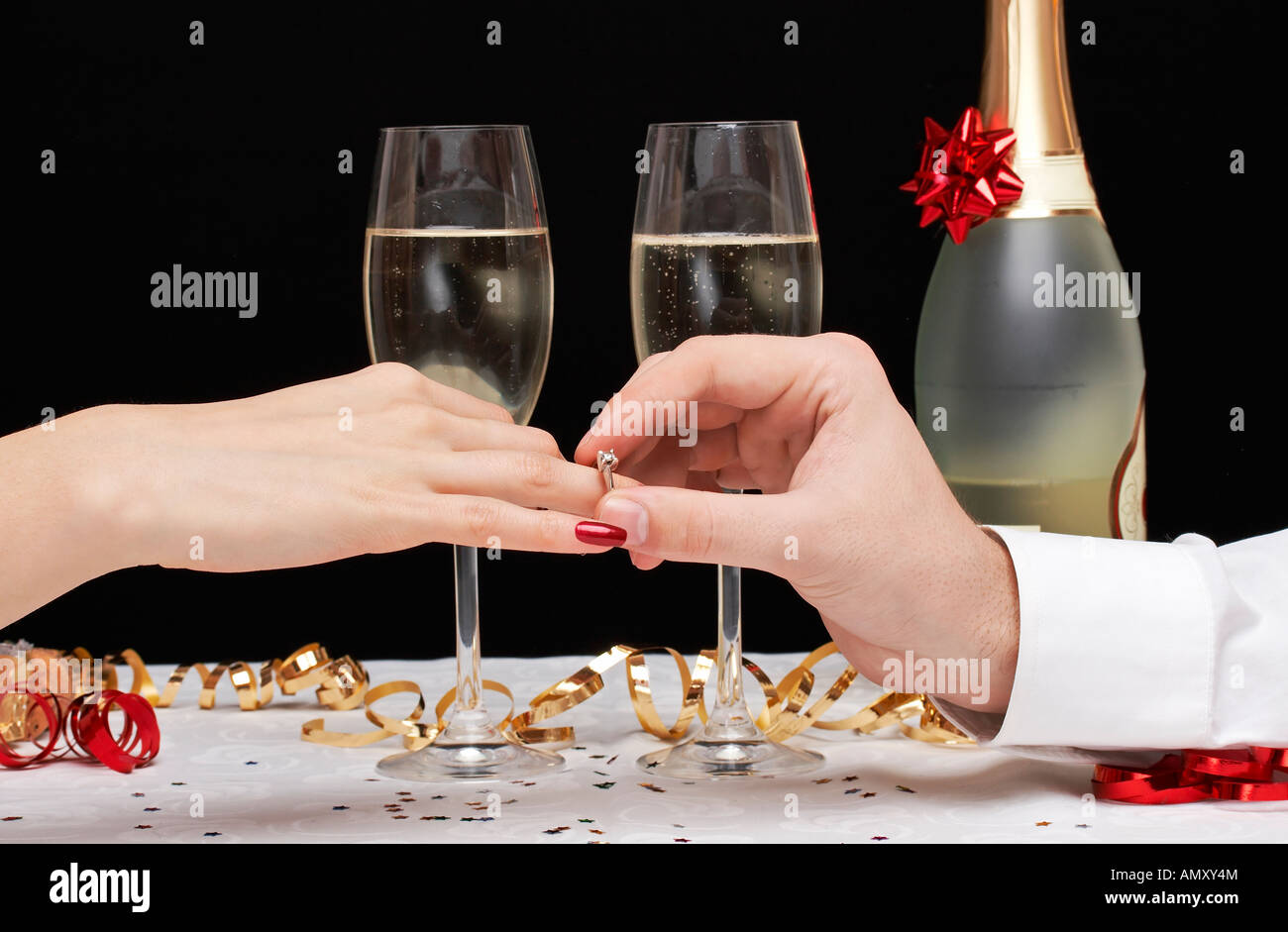 man proposing and putting a ring on a woman's finger Stock Photo - Alamy