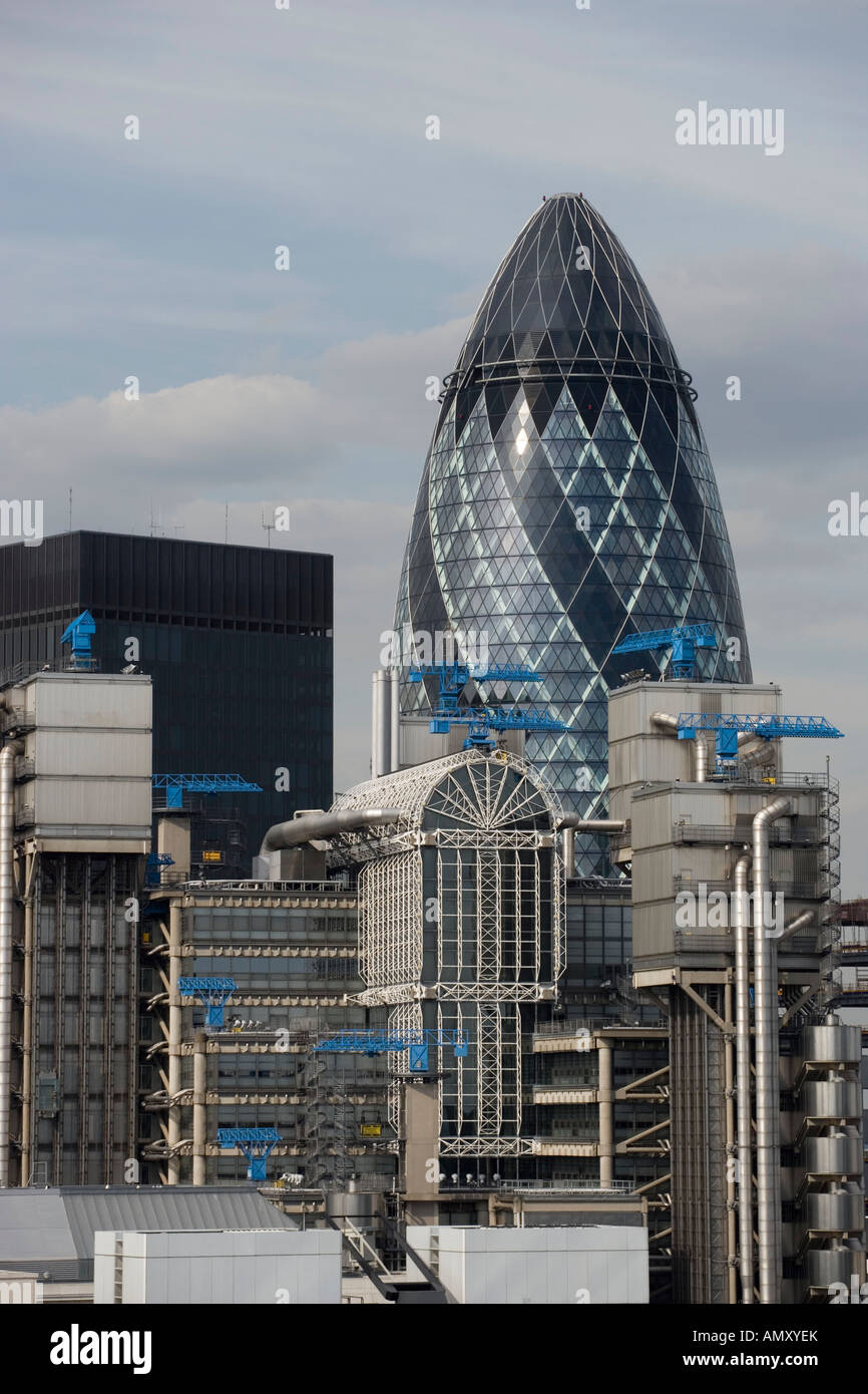 Buildings in city against overcast sky, 30 St Mary Axe, London, England ...