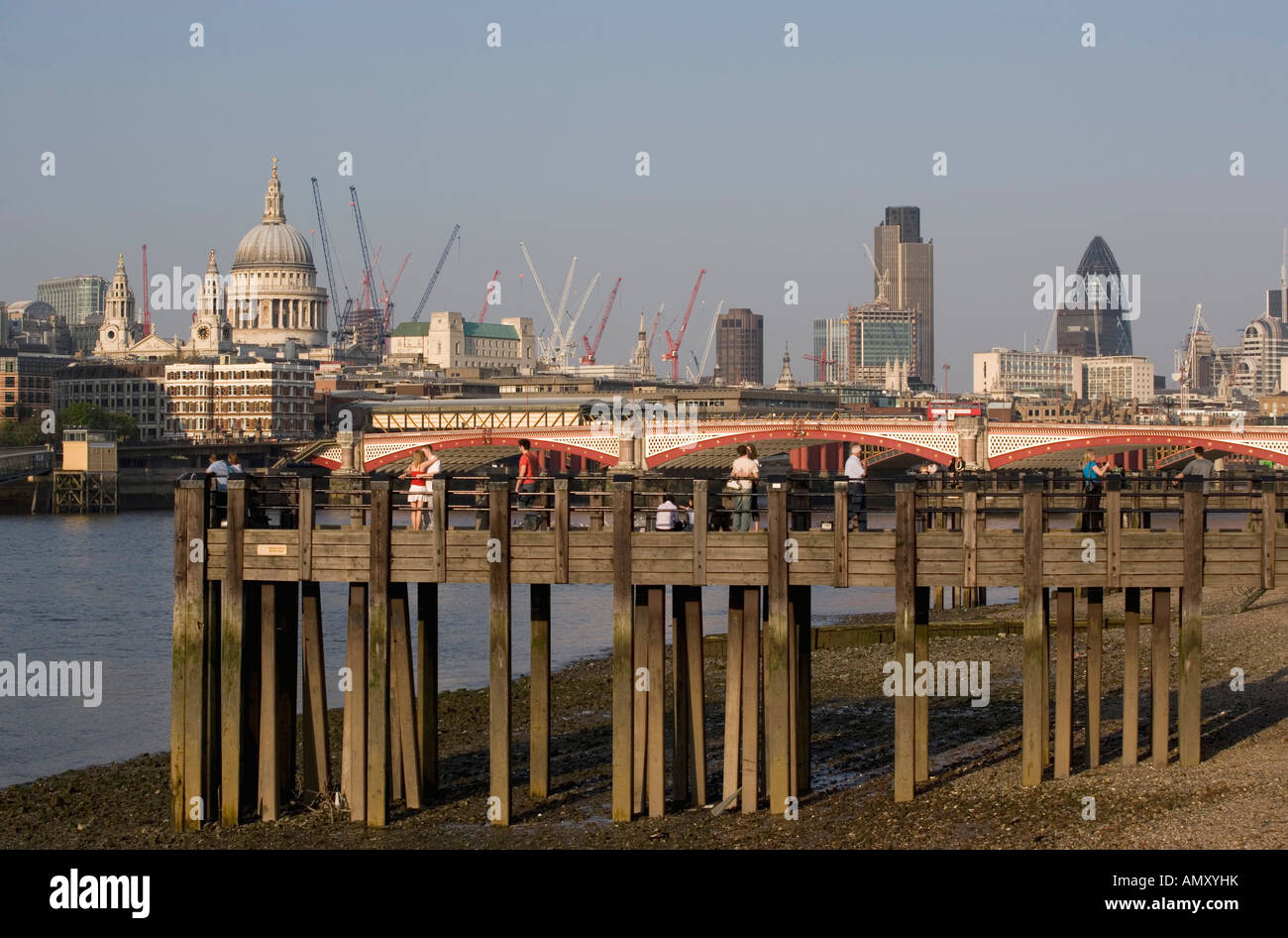 Tourists on wooden pier at riverside, St. Pauls Cathedral, London ...