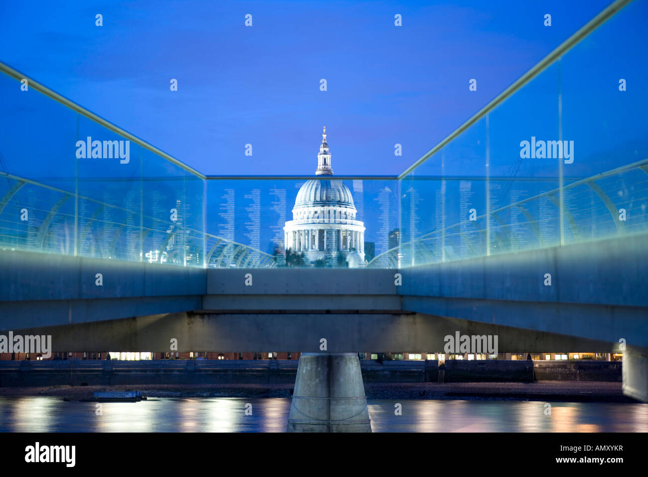 Bridge across river lit up at dusk, Millennium Bridge, St. Pauls ...