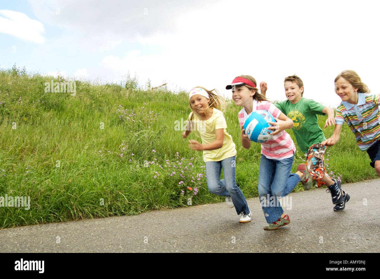 Child chasing ball hi-res stock photography and images - Alamy
