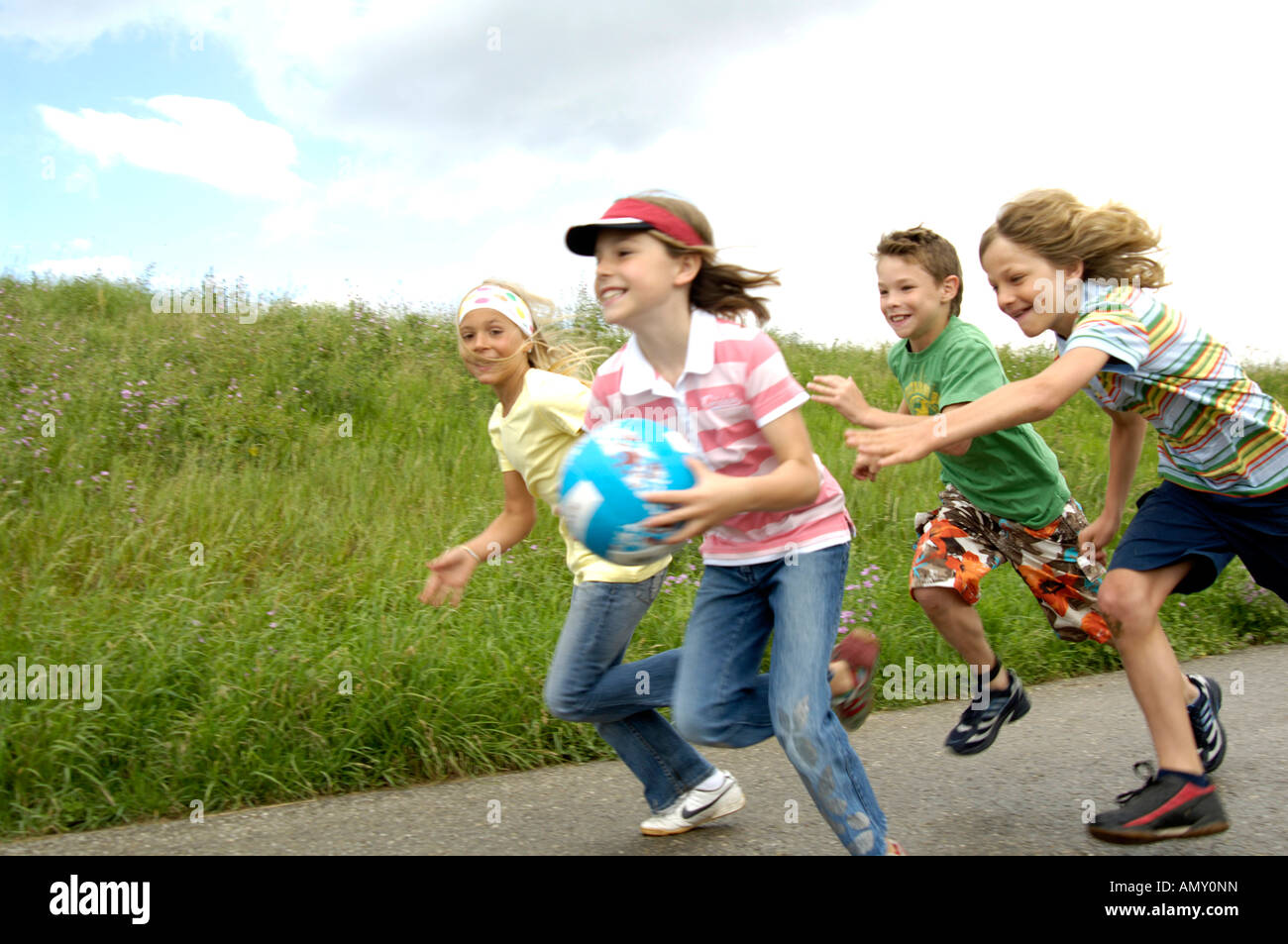 Child chasing ball hi-res stock photography and images - Alamy