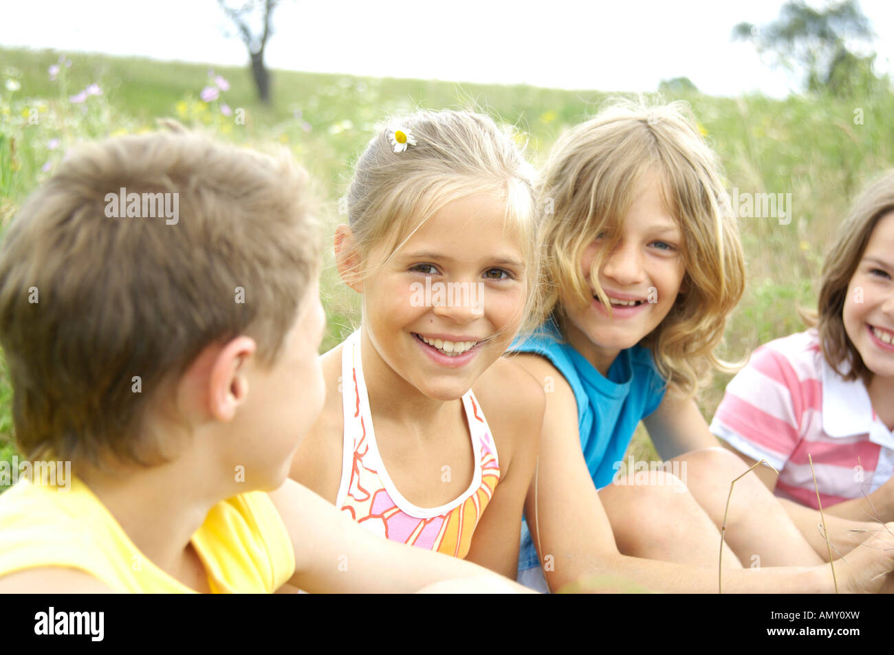 Four seated children hi-res stock photography and images - Alamy
