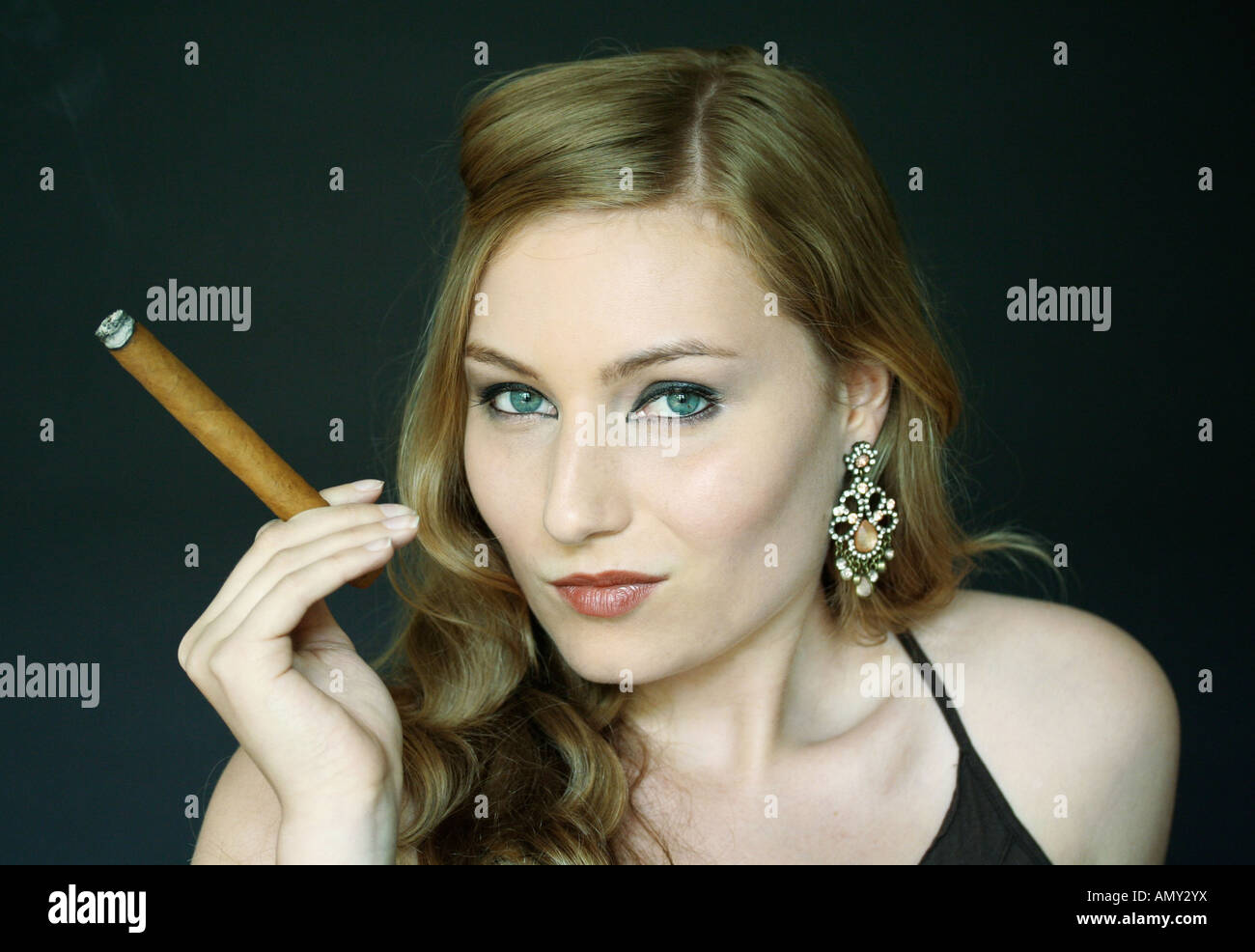 Young woman holding cigar Stock Photo - Alamy