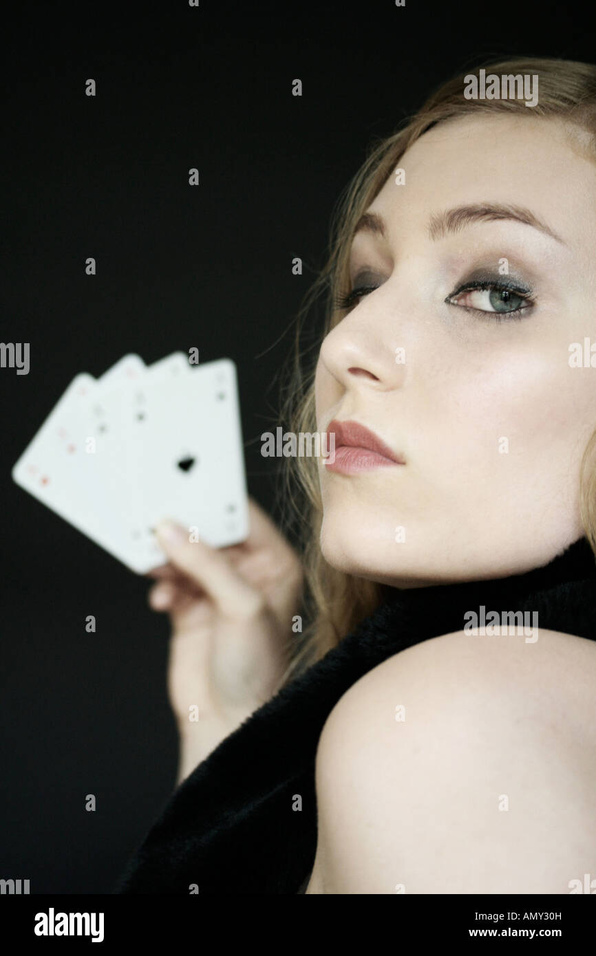 Portrait of young woman playing cards Stock Photo - Alamy