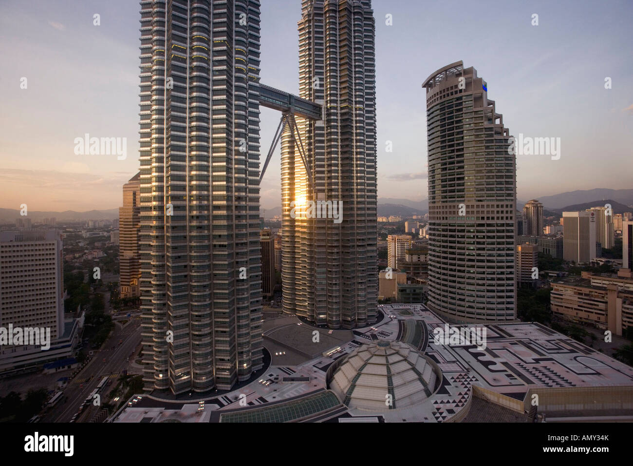 Twin skyscrapers in city at dusk, Petronas Towers, Kuala Lumpur ...