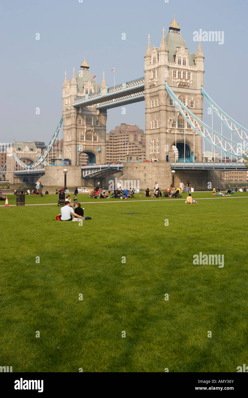 Tourists relaxing near bridge, Tower Bridge, London, England Stock ...