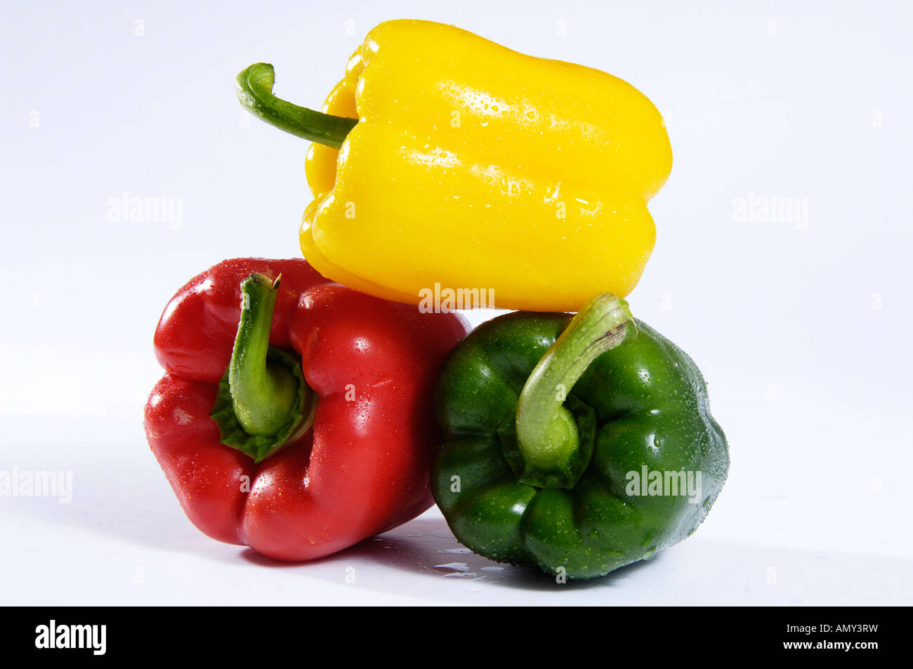 Close-up of three bell peppers against white background Stock Photo - Alamy