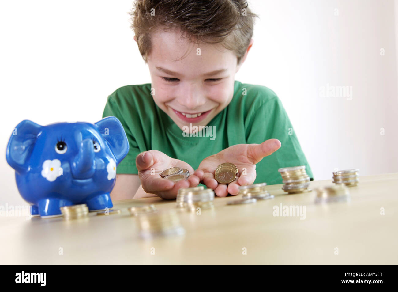 Close-up of boy holding coins and smiling Stock Photo - Alamy