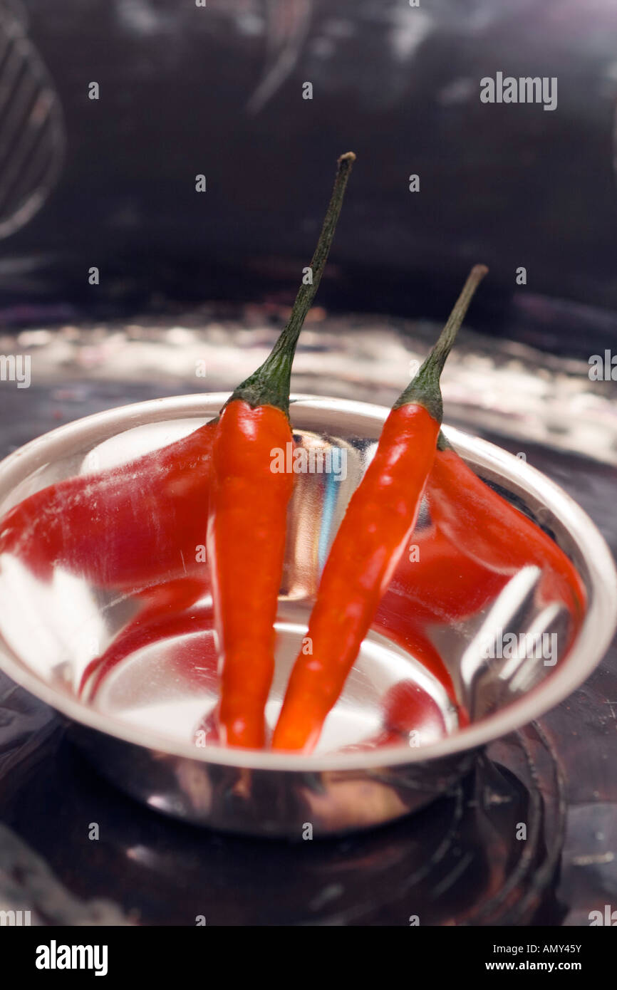 Two red chilli peppers in bowl Stock Photo - Alamy