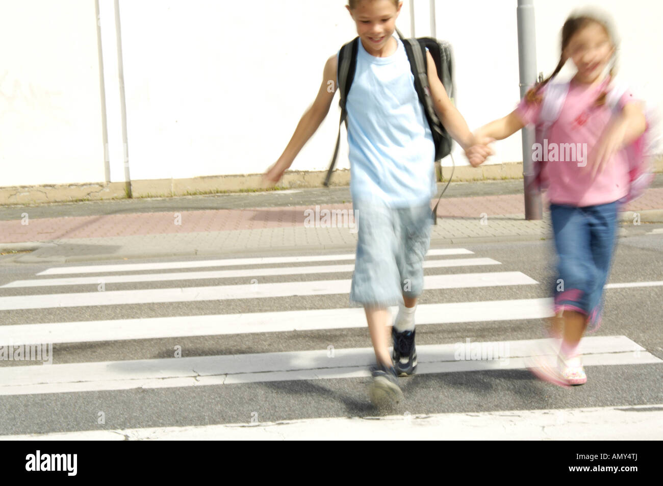Boy and girl zebra crossing Stock Photo - Alamy