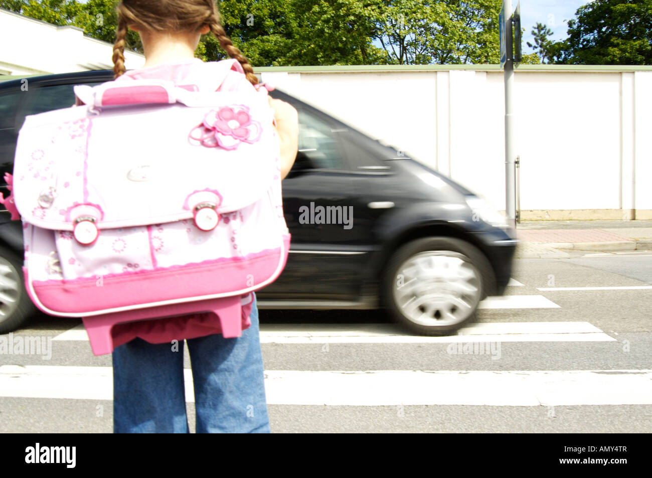 Rear view of girl waiting at roadside Stock Photo - Alamy