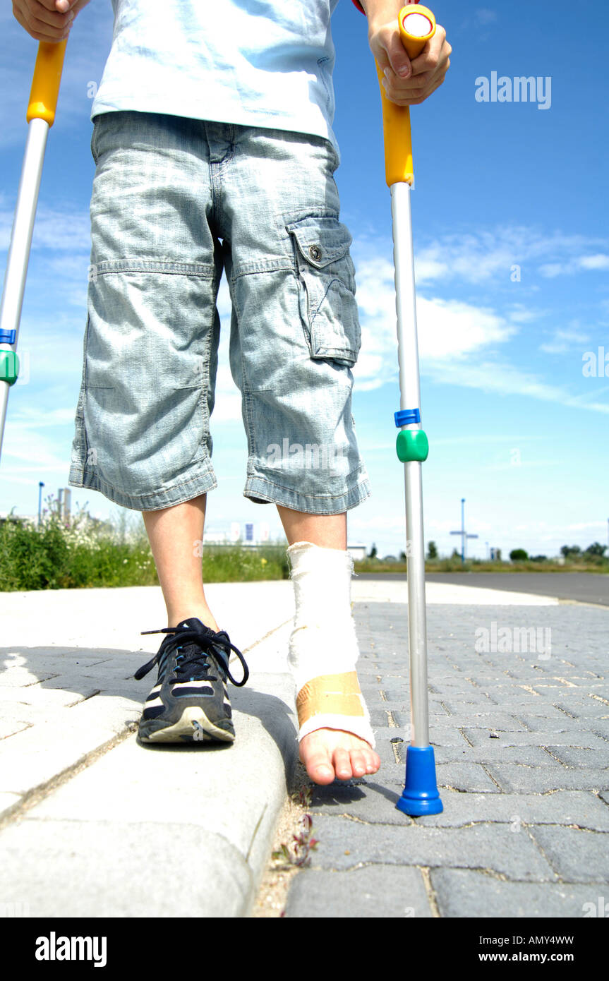 Low section view of boy walking on road with broken leg Stock Photo - Alamy