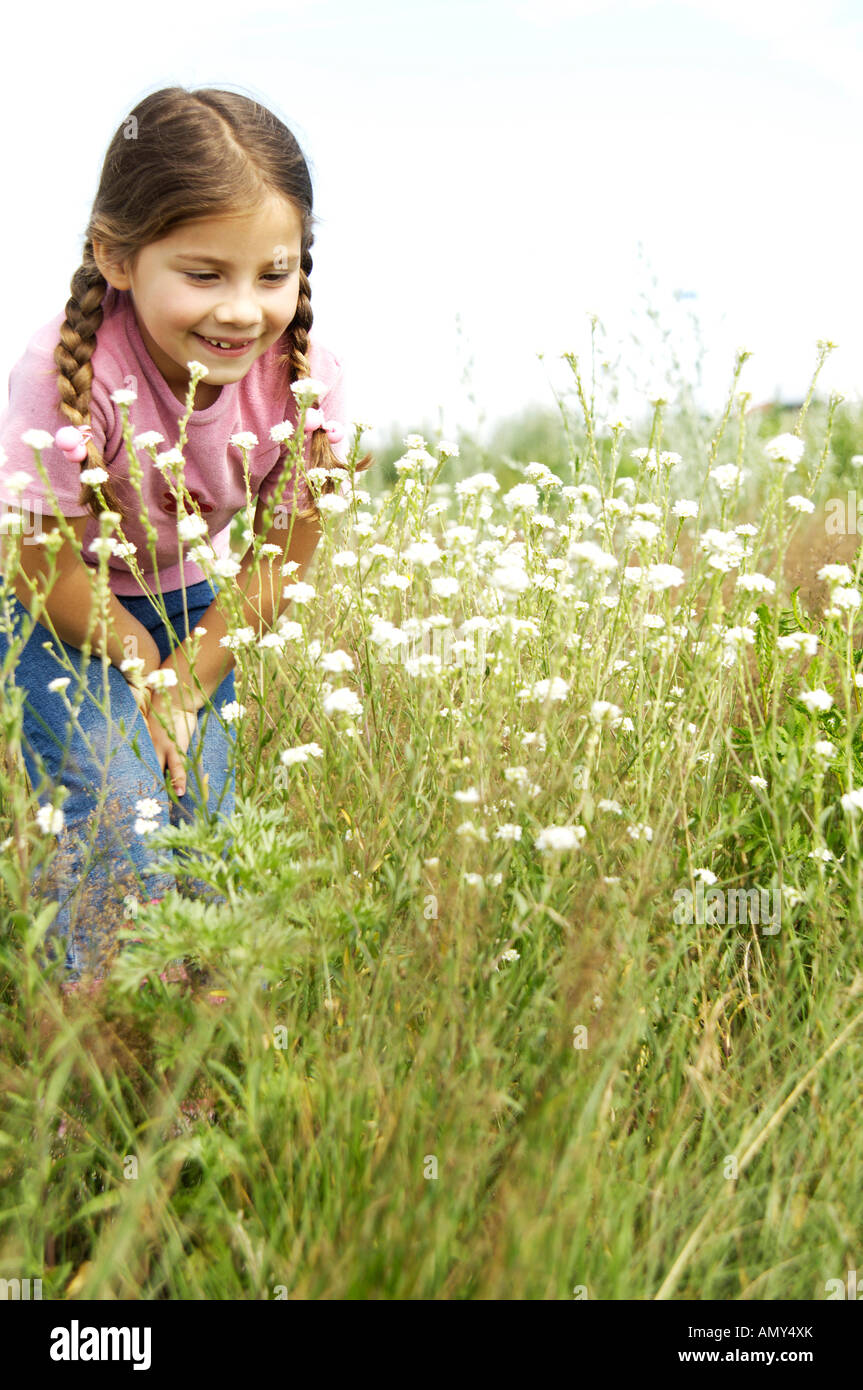 Girl walking in field and smiling Stock Photo - Alamy