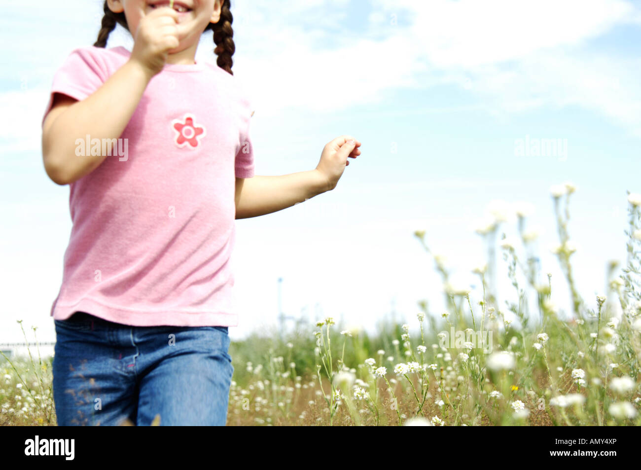 Girl running in field Stock Photo - Alamy