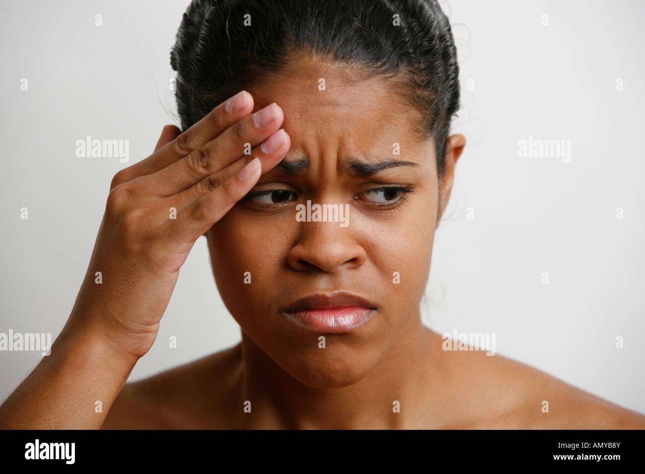 Woman with finger on her forehead hi-res stock photography and images ...
