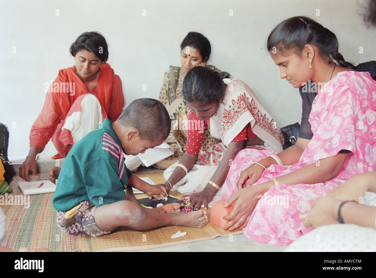 Young Indian boy with congenital spasticity staff during training ...