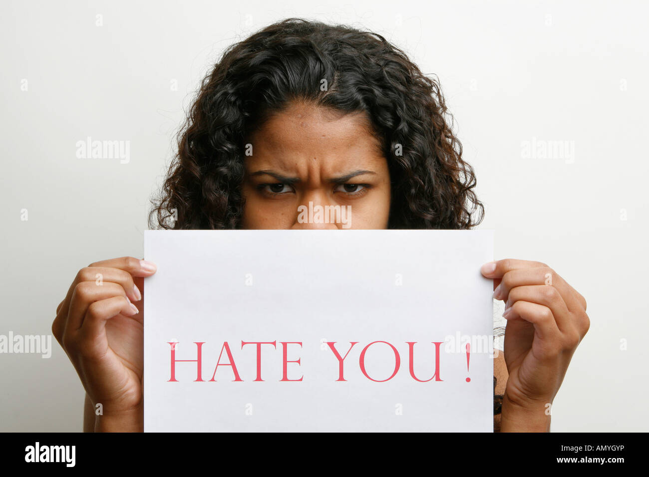 Portrait of a young woman holding card with a message - Hate you! MR-12 ...