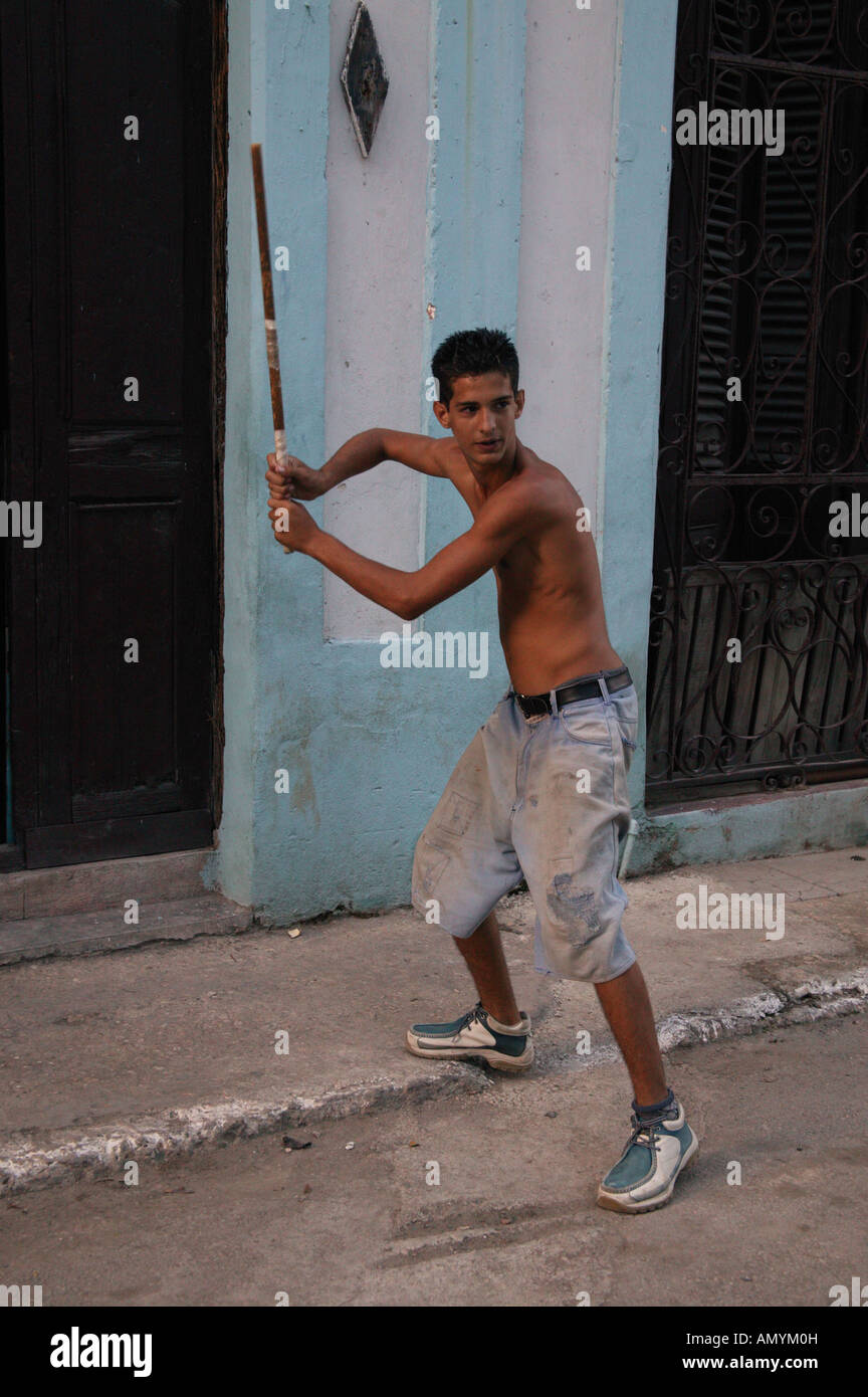 Young man playing baseball in Havana backstreet Stock Photo - Alamy