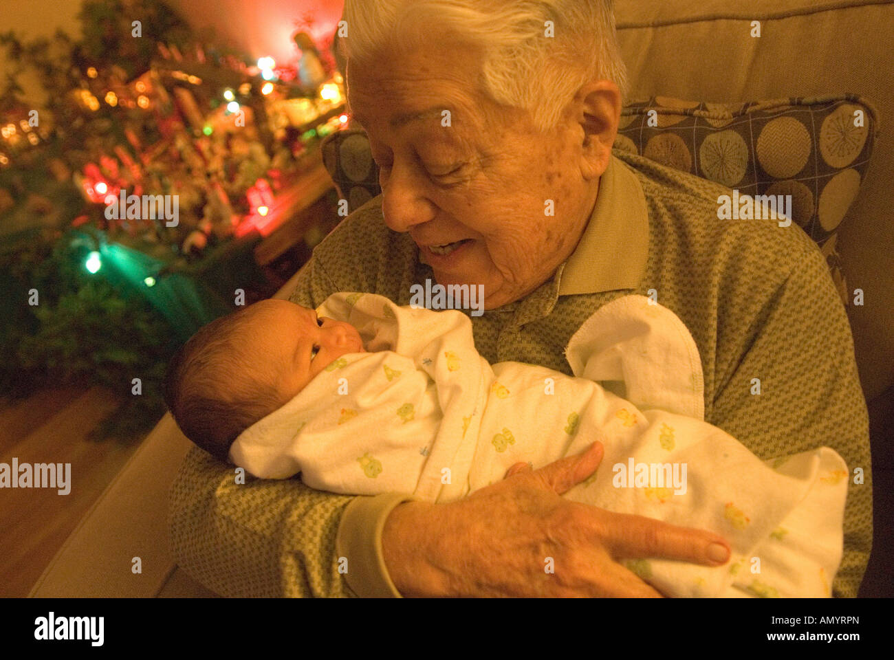 Grandfather holding newborn grandchild hi-res stock photography and ...