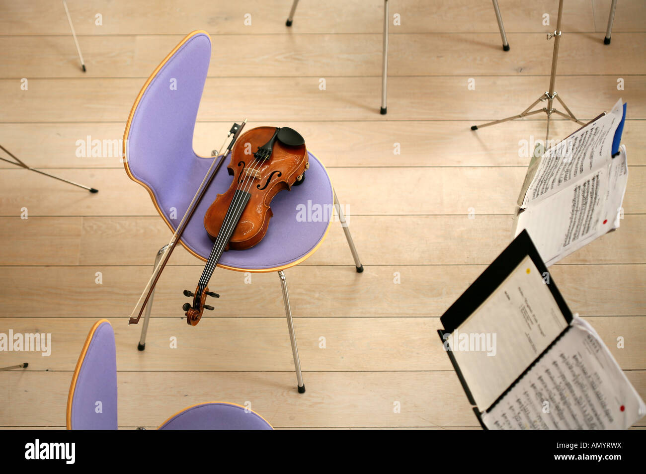 violin on a chair and opened music note book Stock Photo - Alamy