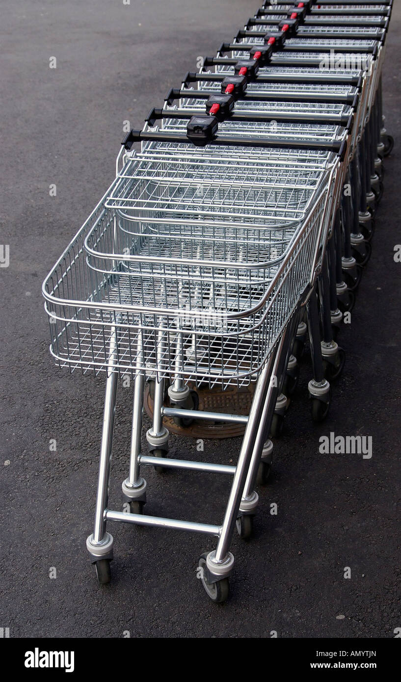 Metal shopping carts outside in a line against parking tarmac Stock ...