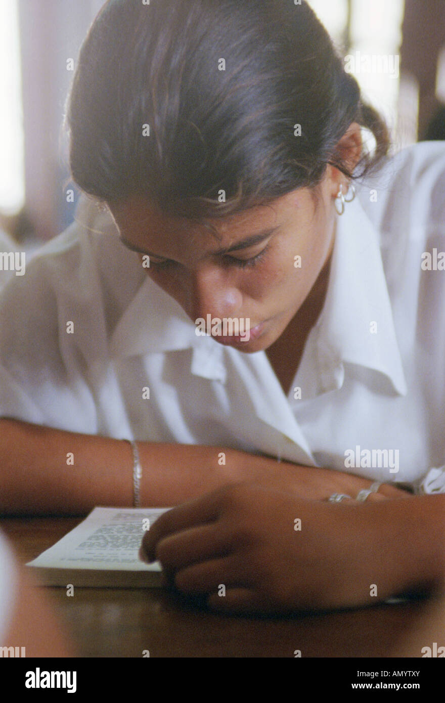 Secondary school girl reading book at desk. Cuba Stock Photo - Alamy
