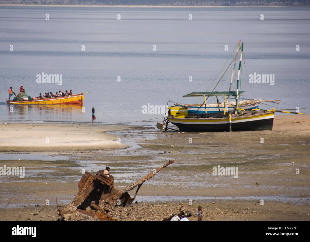 Pemba, Mozambique. Fishermen rowing a dinghy along the shallow waters ...
