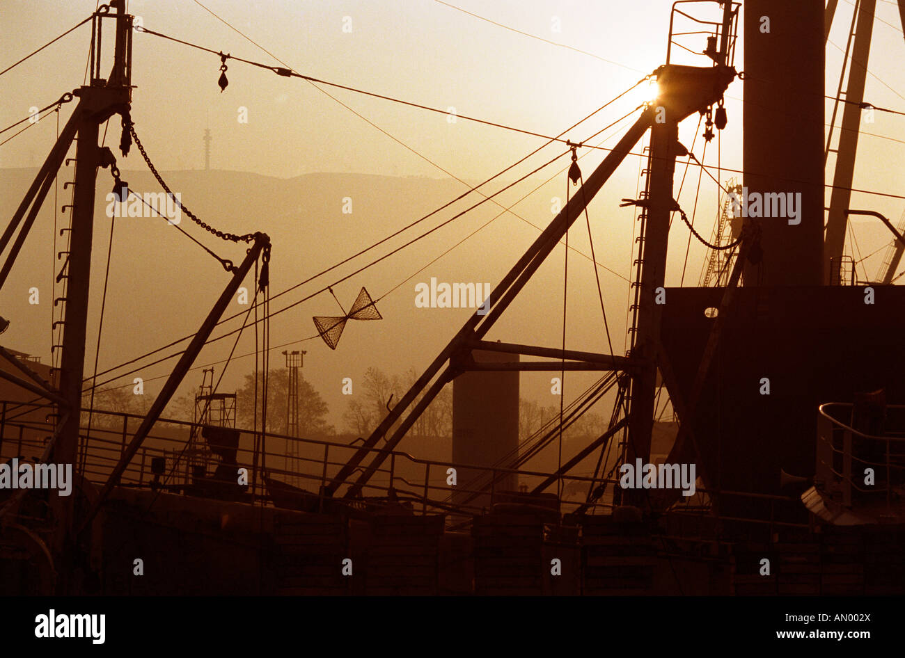 TRAWLER MASTS SILHOUETTED IN DOCKS Stock Photo - Alamy