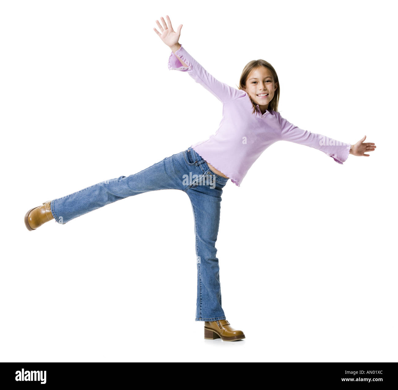 Portrait of a girl standing on one leg with her arms outstretched Stock ...