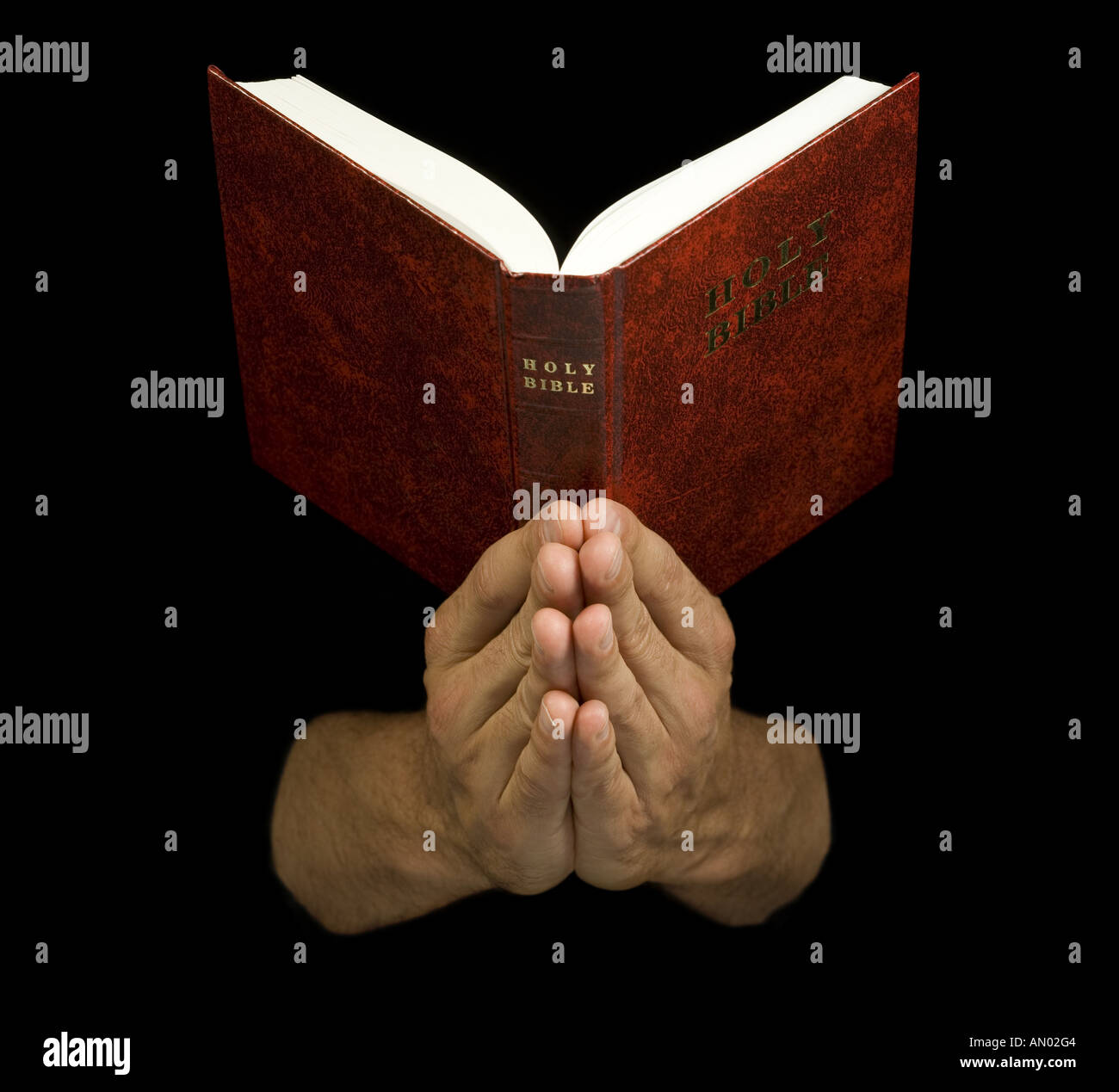 Close up of a praying hands holding a Bible Stock Photo - Alamy