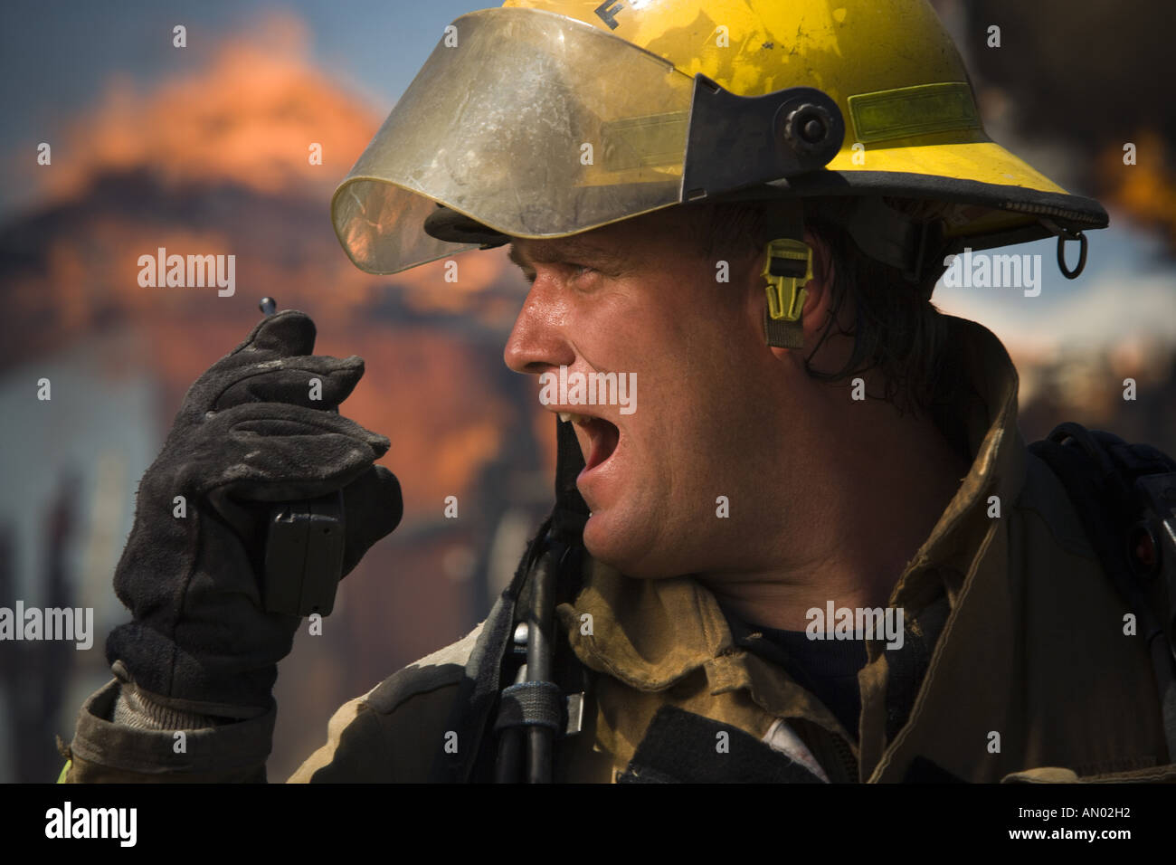 Profile of a firefighter using a walkie talkie Stock Photo - Alamy