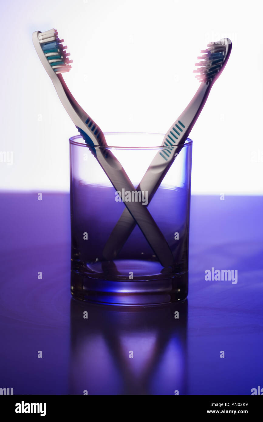 Tooth brushes in glass cup hi-res stock photography and images - Alamy